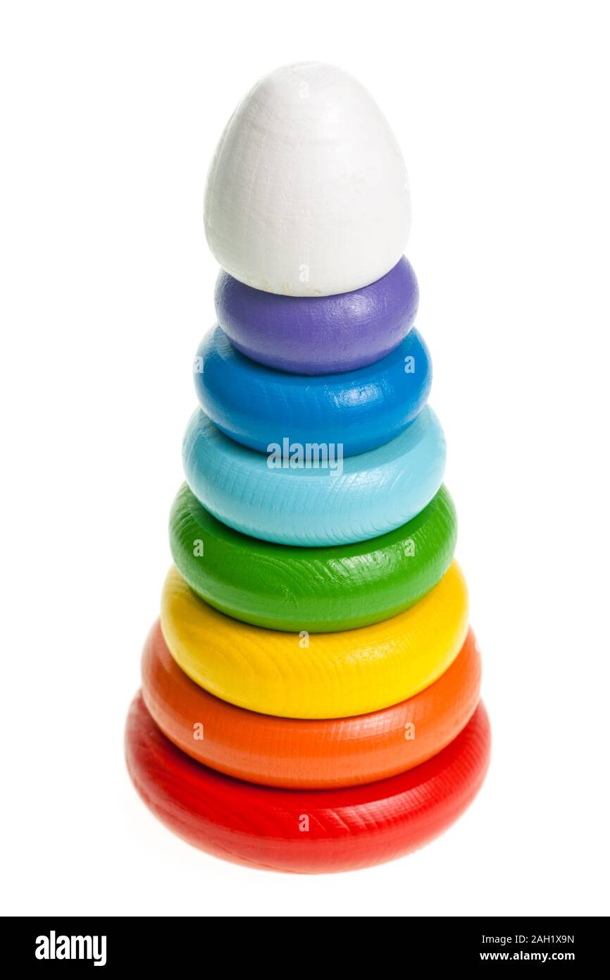 Colorful wooden pyramid toy on white background Stock Photo - Alamy