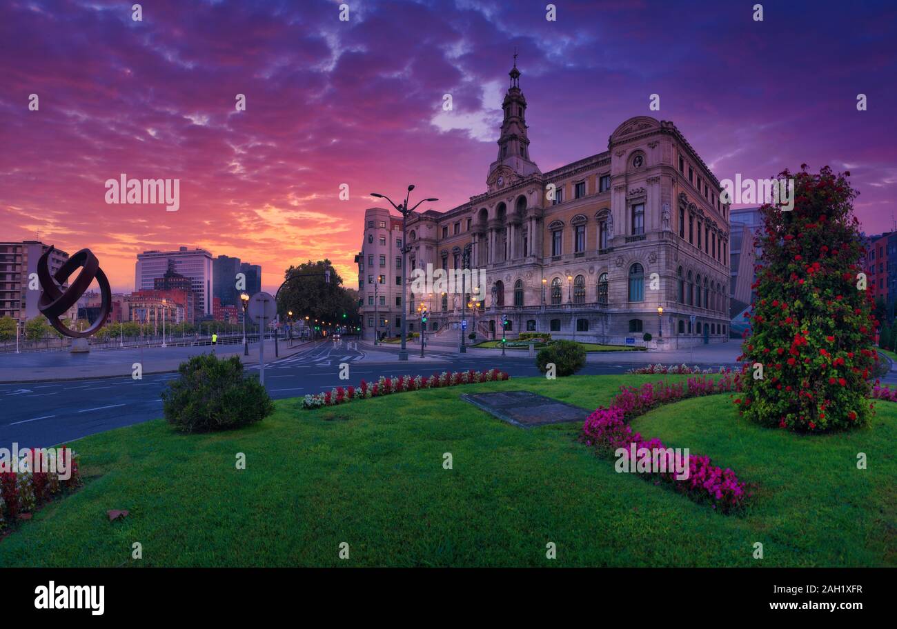 Landscaped roundabout in front of the town hall building in the city of ...