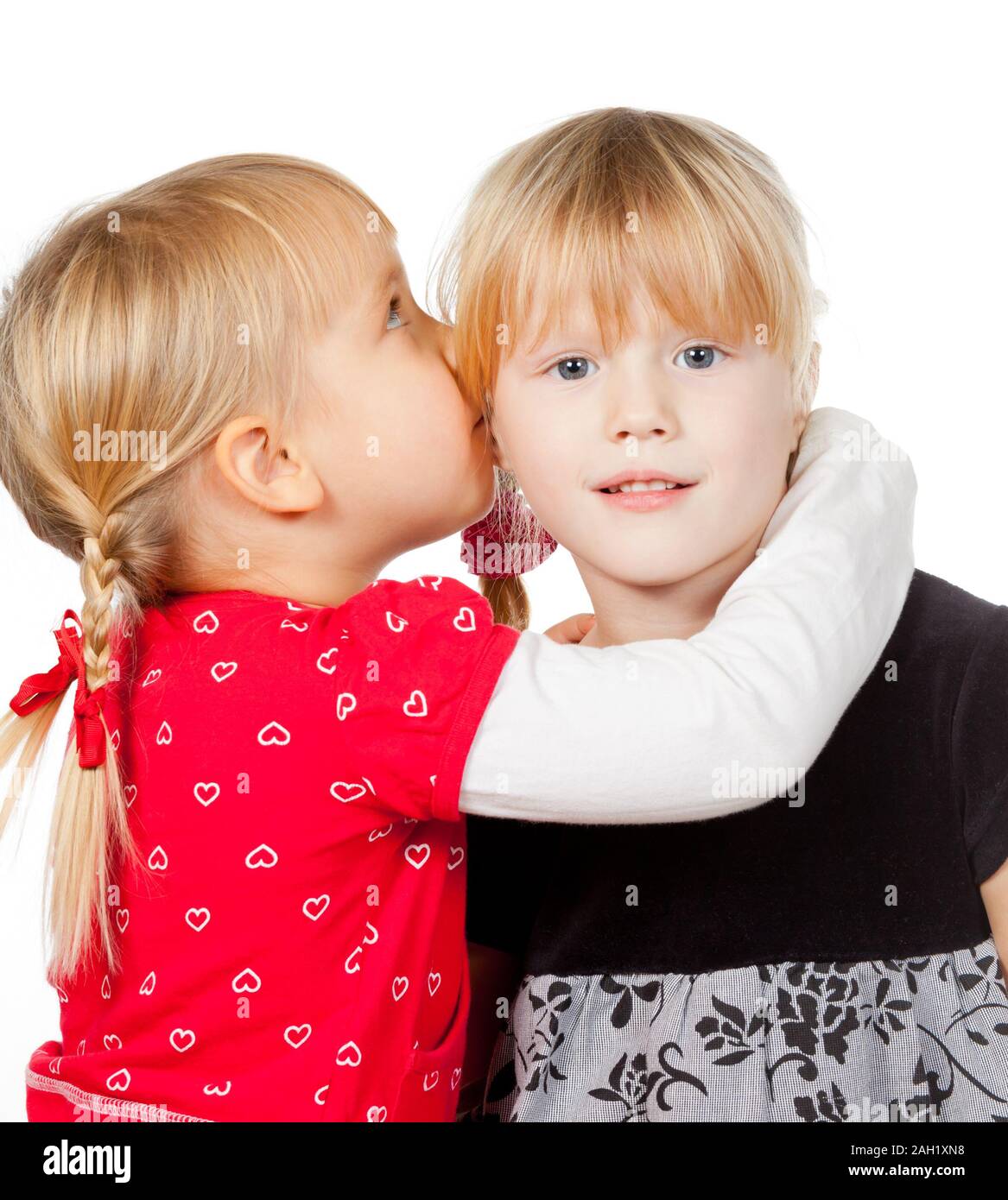 Portrait of little girl telling a secret to her friend over a white ...