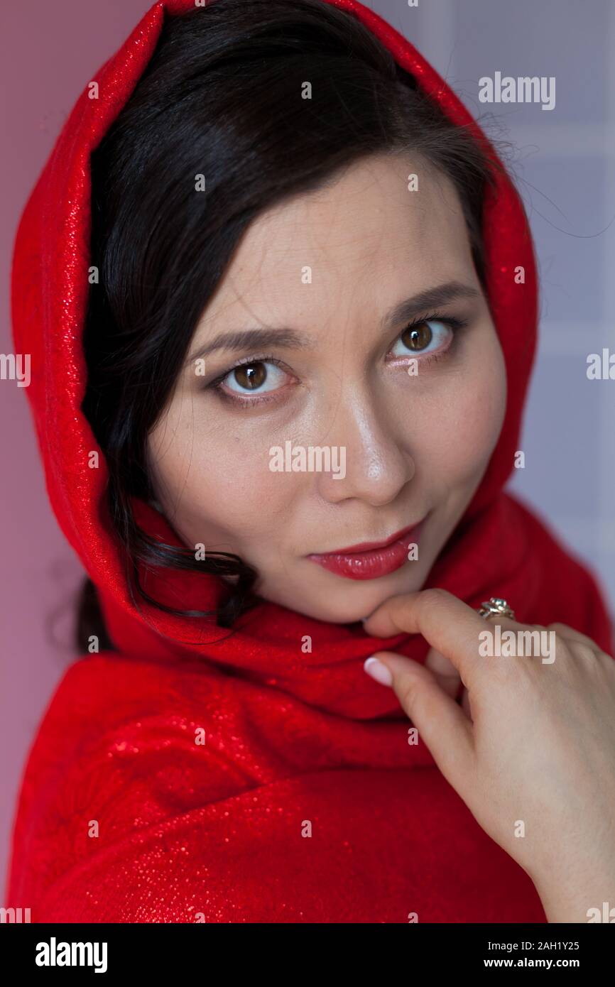 portrait of a beautiful fashionable Asian woman with a red Muslim ...