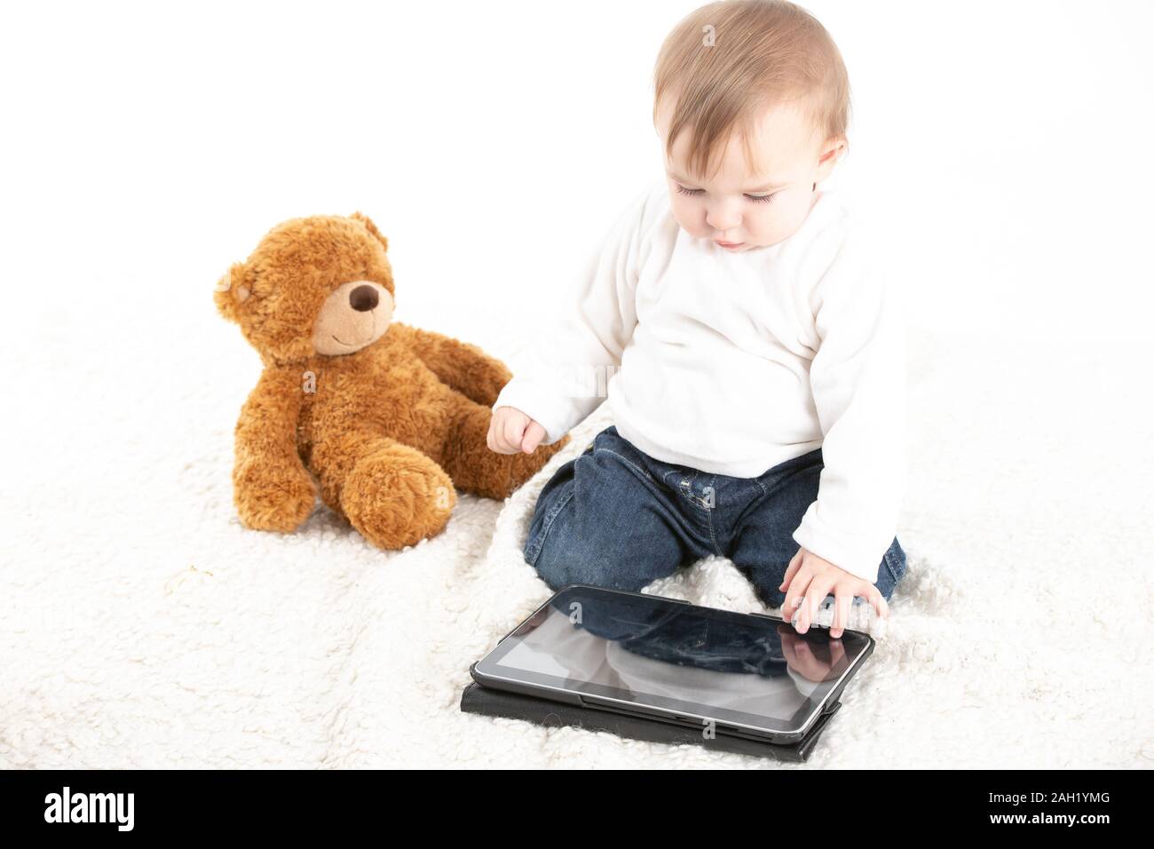 Stock studio photo with a white background of a baby looking at the ...