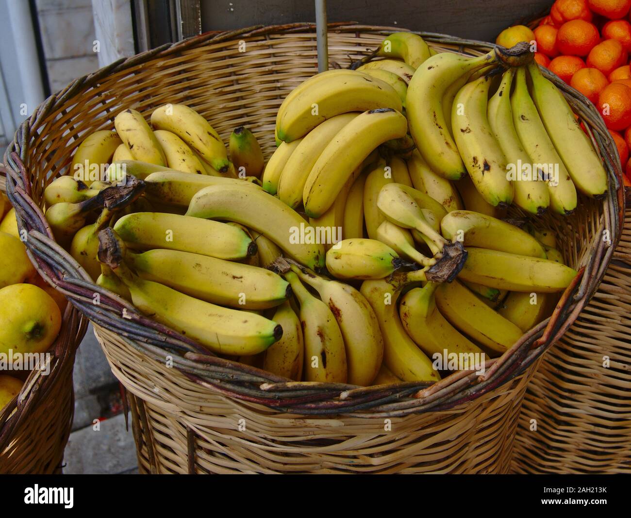 a wicker basket full of bananas Stock Photo - Alamy