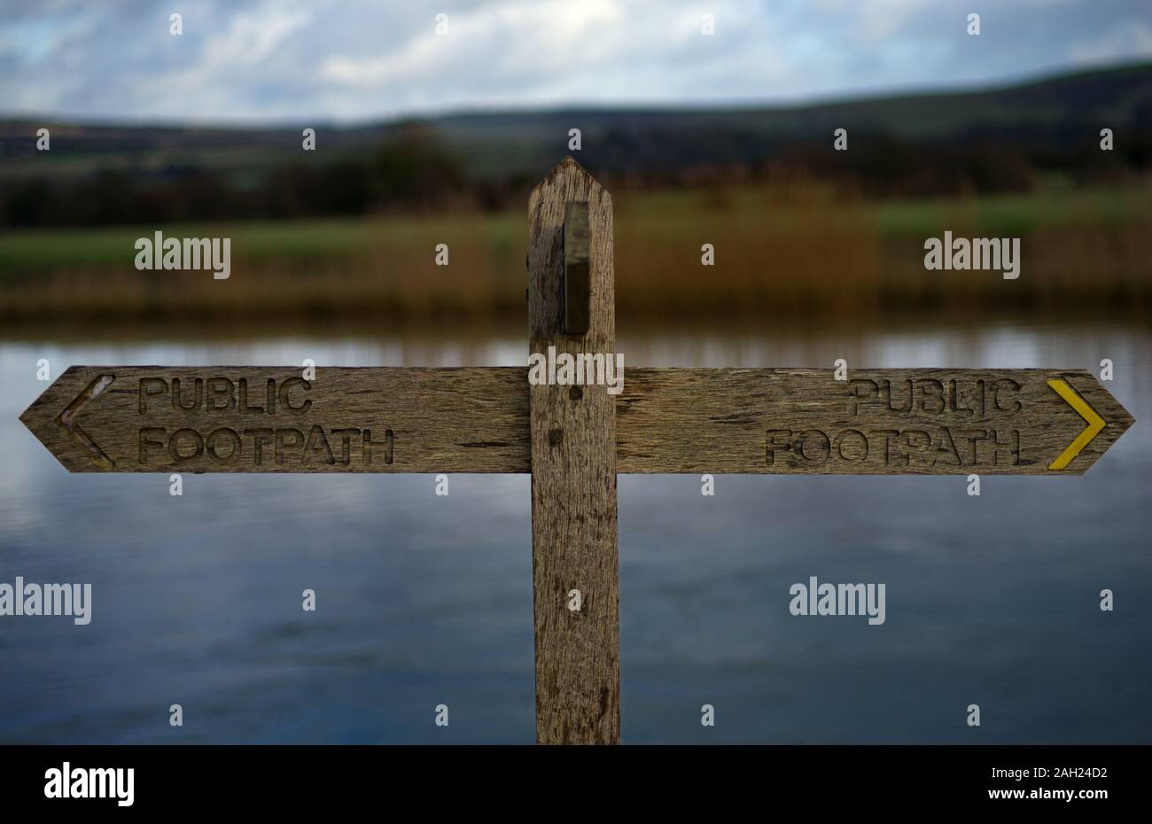 public footpath sign pointing left and right Stock Photo - Alamy