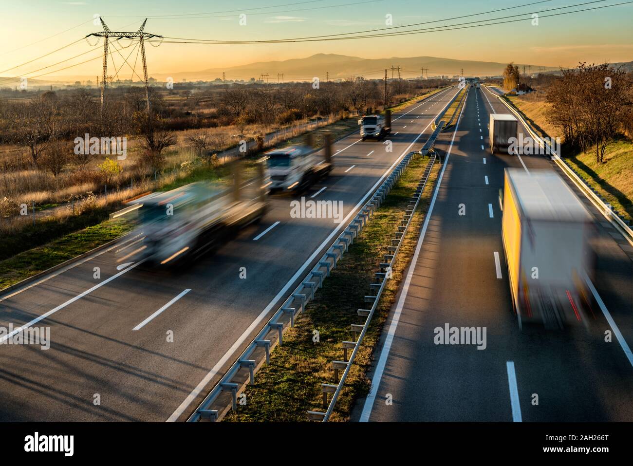 High intensity highway traffic with Delivery Lorry trucks passing in ...