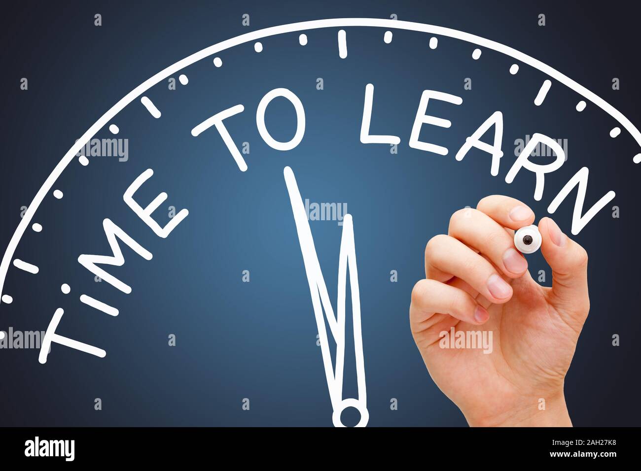 Hand writing Time to Learn on a clock with white marker on transparent ...