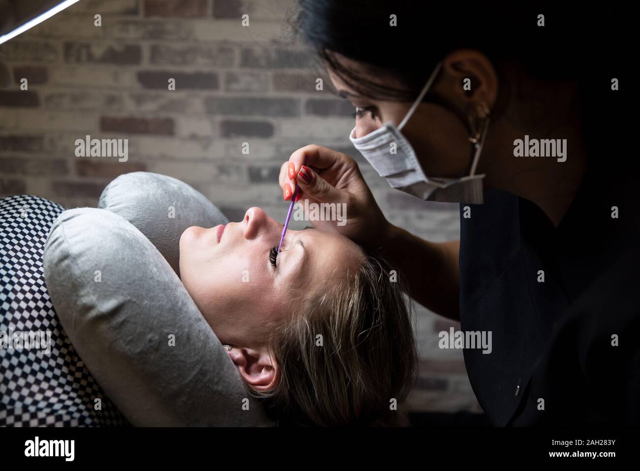 Application of glue on eyelashes, fixing. Cosmetic procedure of eyelash ...