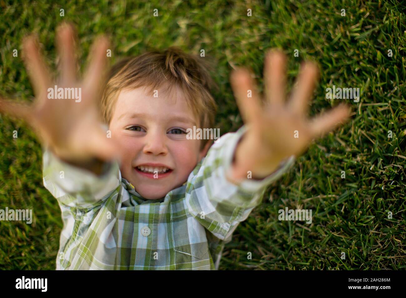 Young boy running though laundry hanging on a clothes line Stock Photo ...