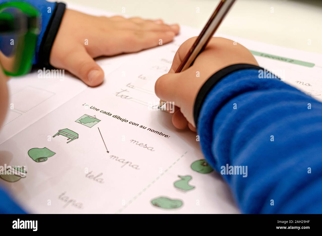 Child learning to write and doing homework at school Stock Photo - Alamy