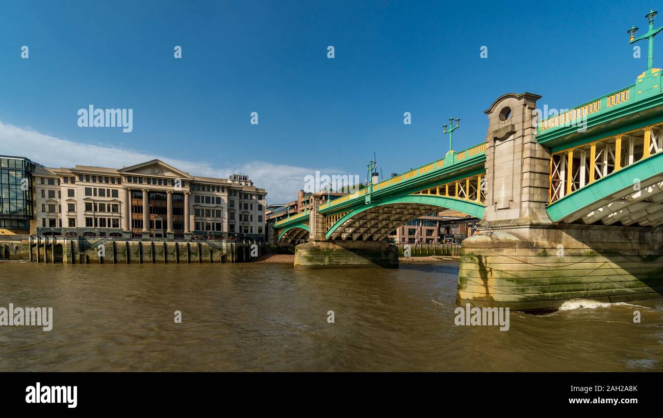 Southwark Bridge in London with some historic buildings, England, UK ...
