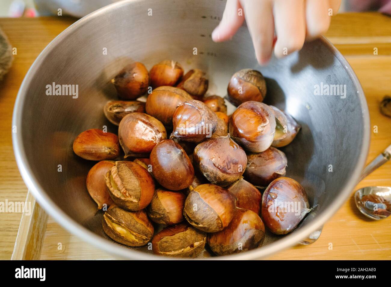 Roasted chestnuts are in a container Stock Photo - Alamy
