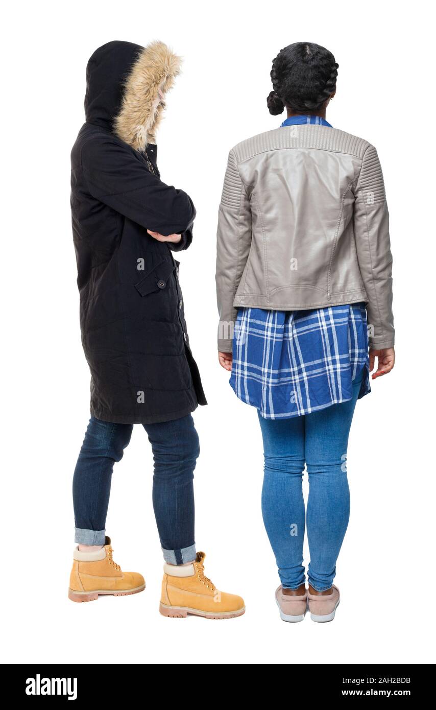 Back view of two young girl in winter jacket. Rear view people ...