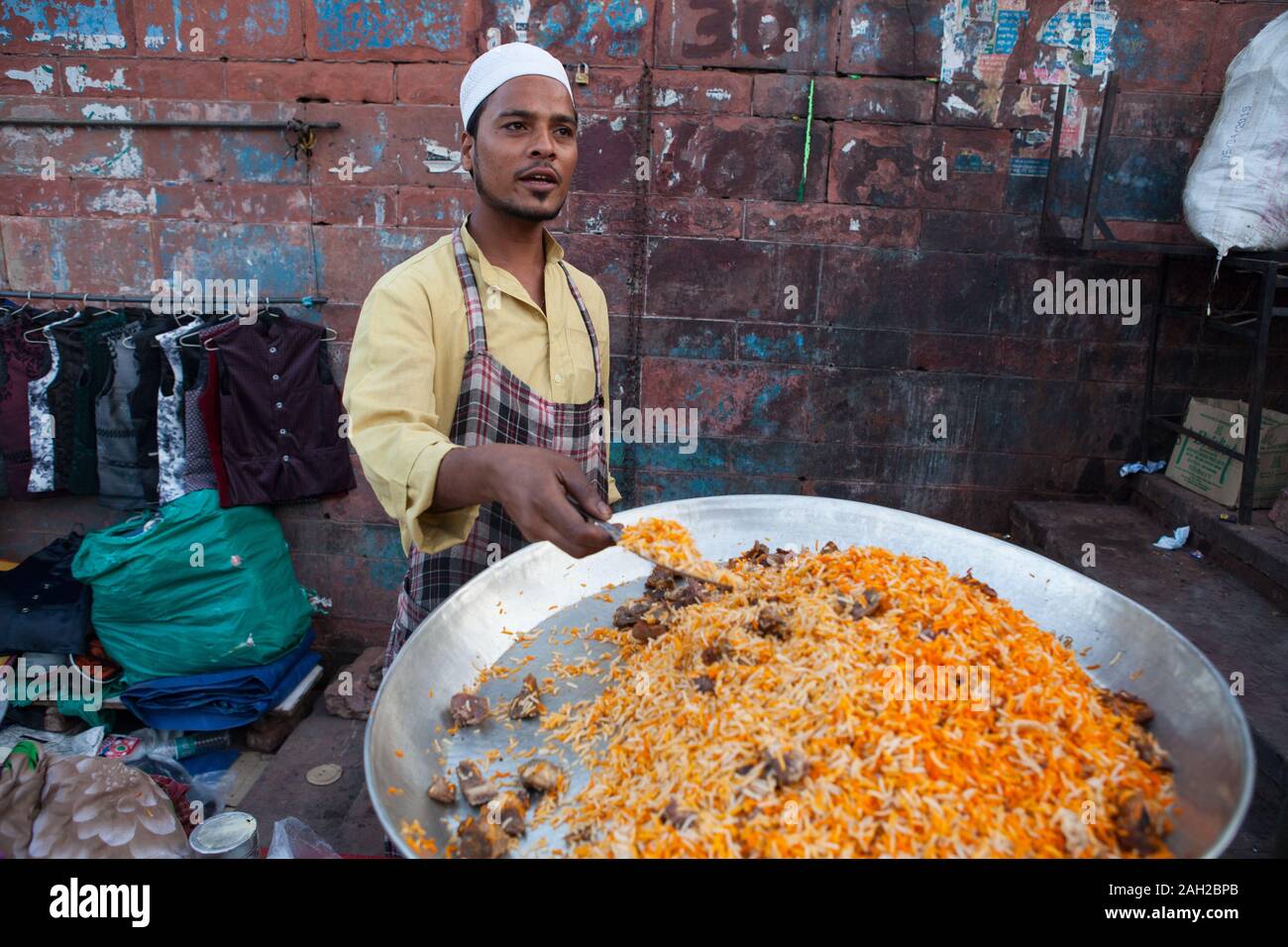 A muslim cook prepares a dish of chicken biryani in the Old City of ...