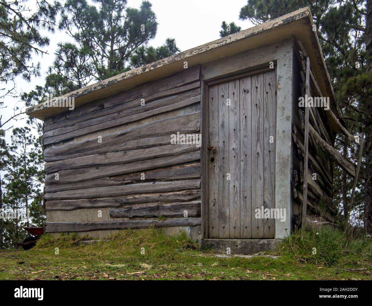 dramatic angle image of an old wooden pump house high in the mountains ...