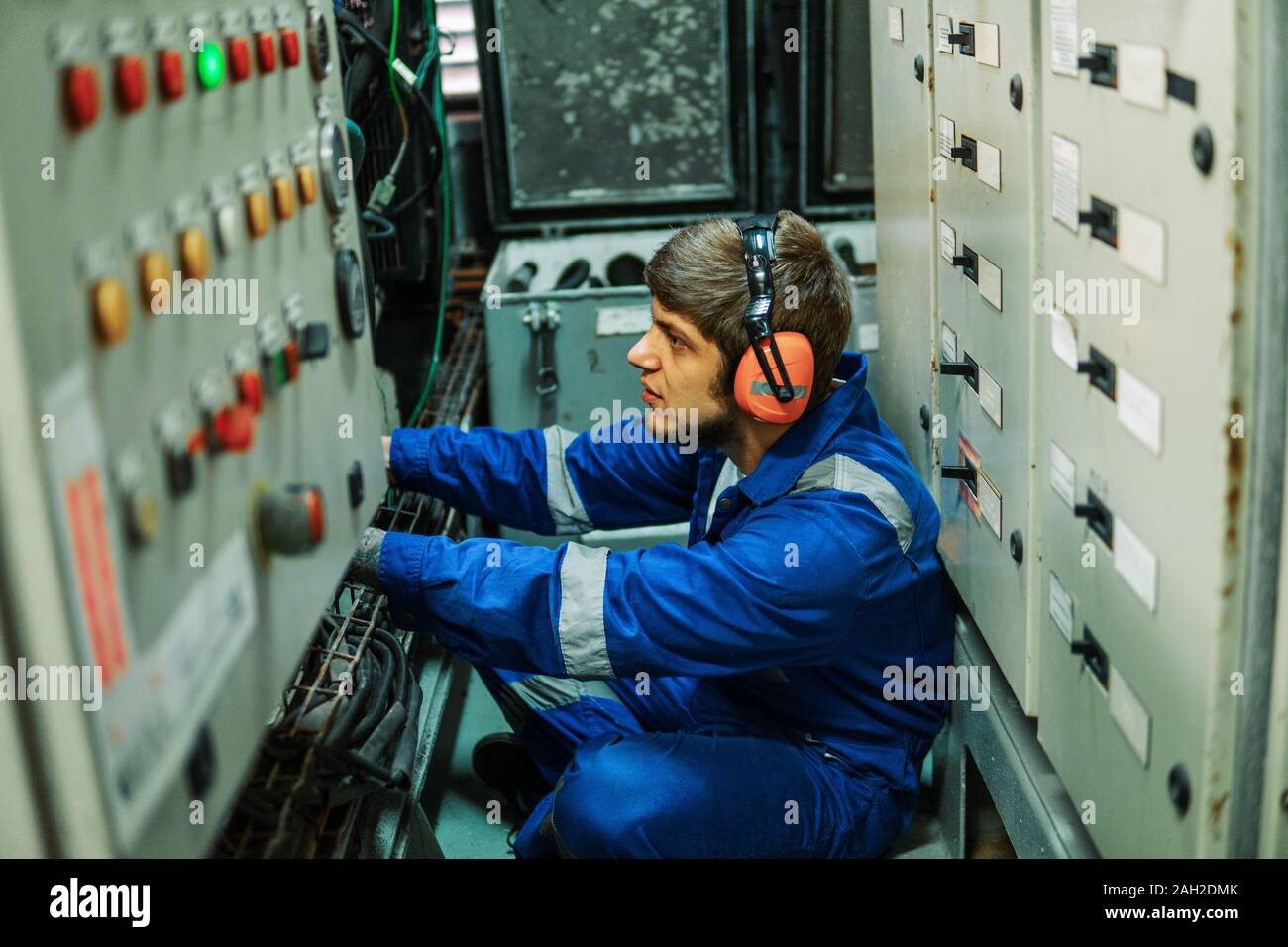 Marine engineer inspecting ship's engine or generators Stock Photo - Alamy