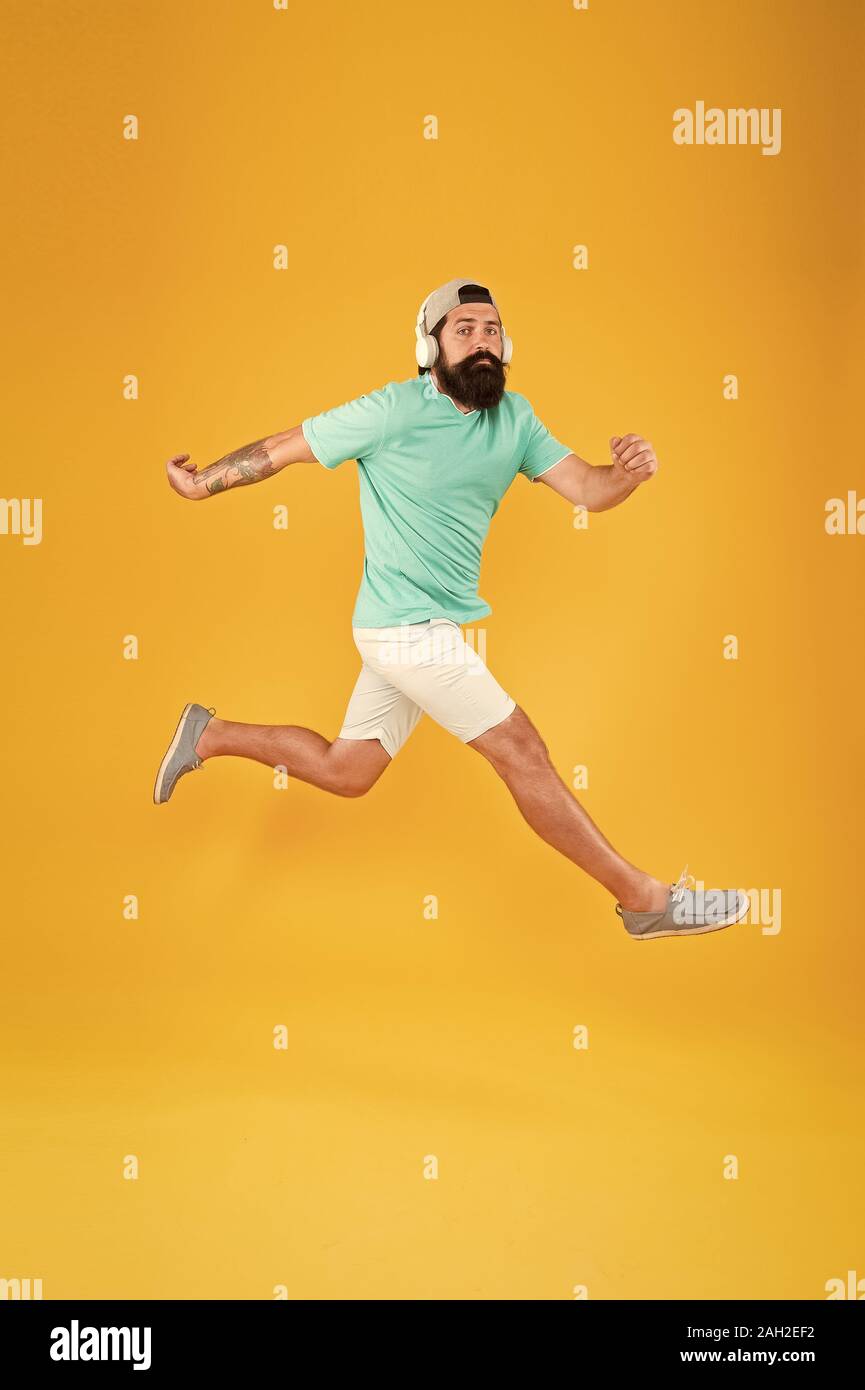 Great music for dancing. Dancer man moving to music on yellow ...