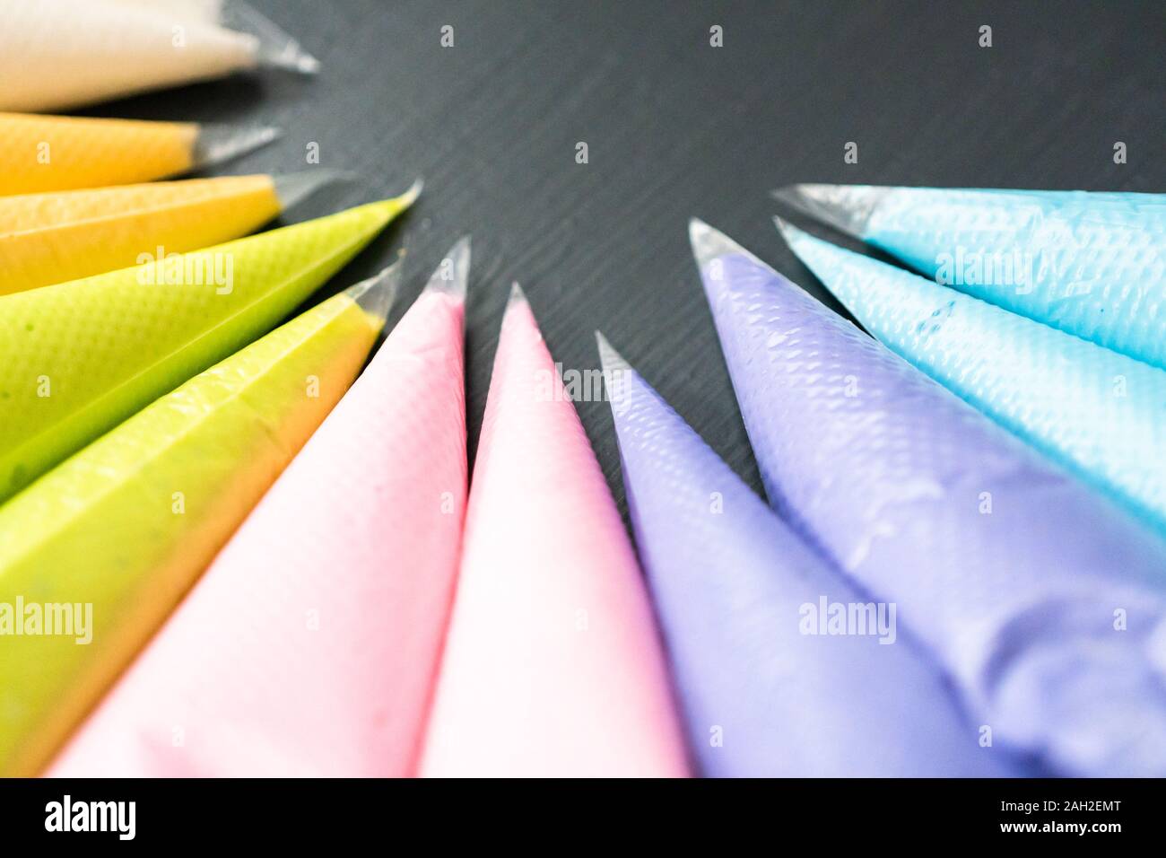 Variety of colors of royal icing in plastic piping bags Stock Photo - Alamy
