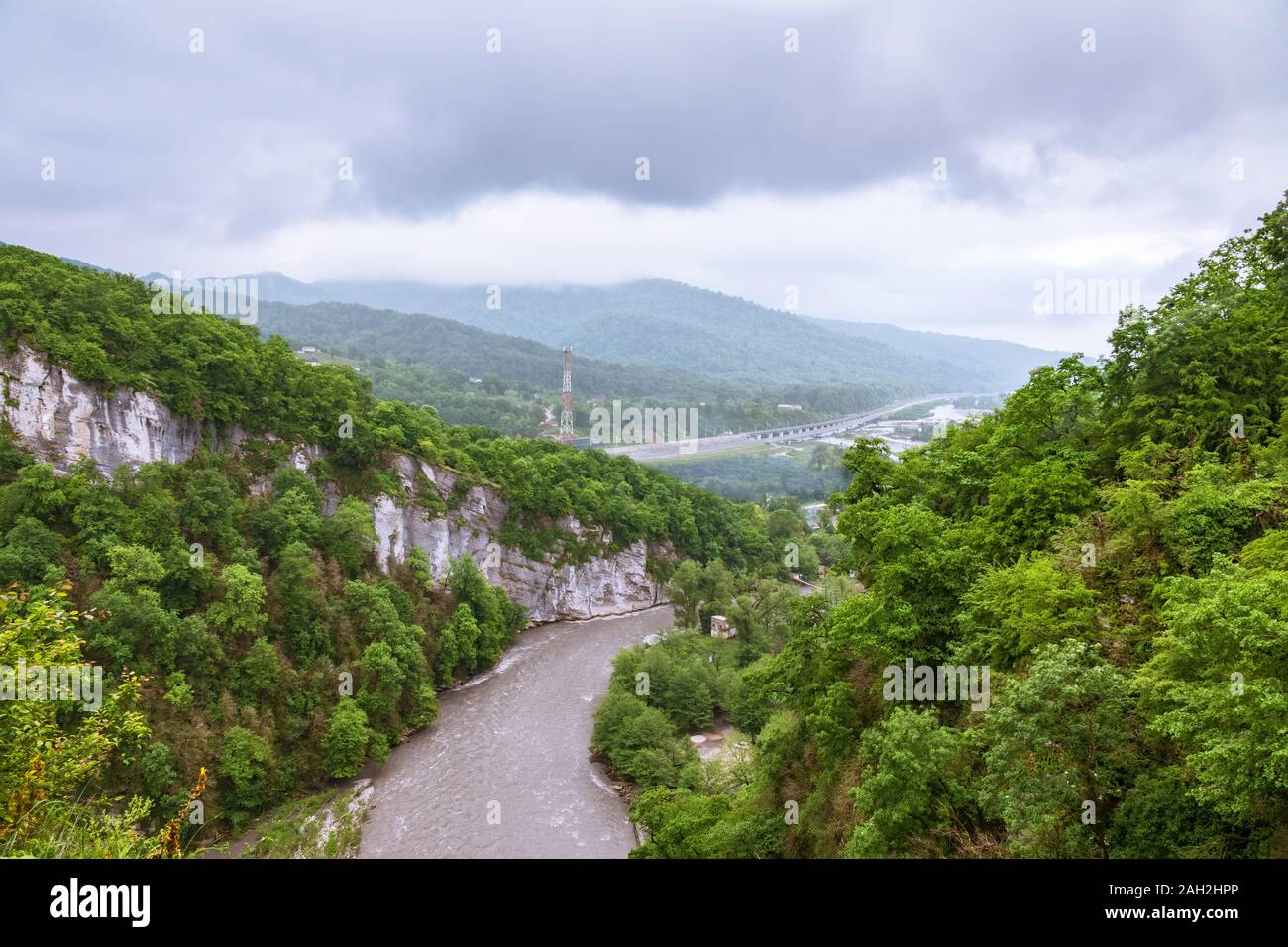 Mountain gorge with a river below. Green mountains in the fog. Canyon ...