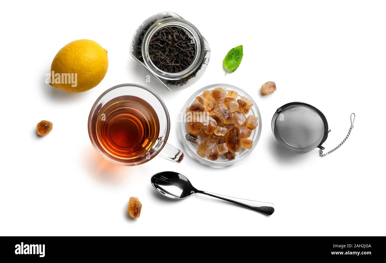 Black tea and accessories top view on white background Stock Photo - Alamy