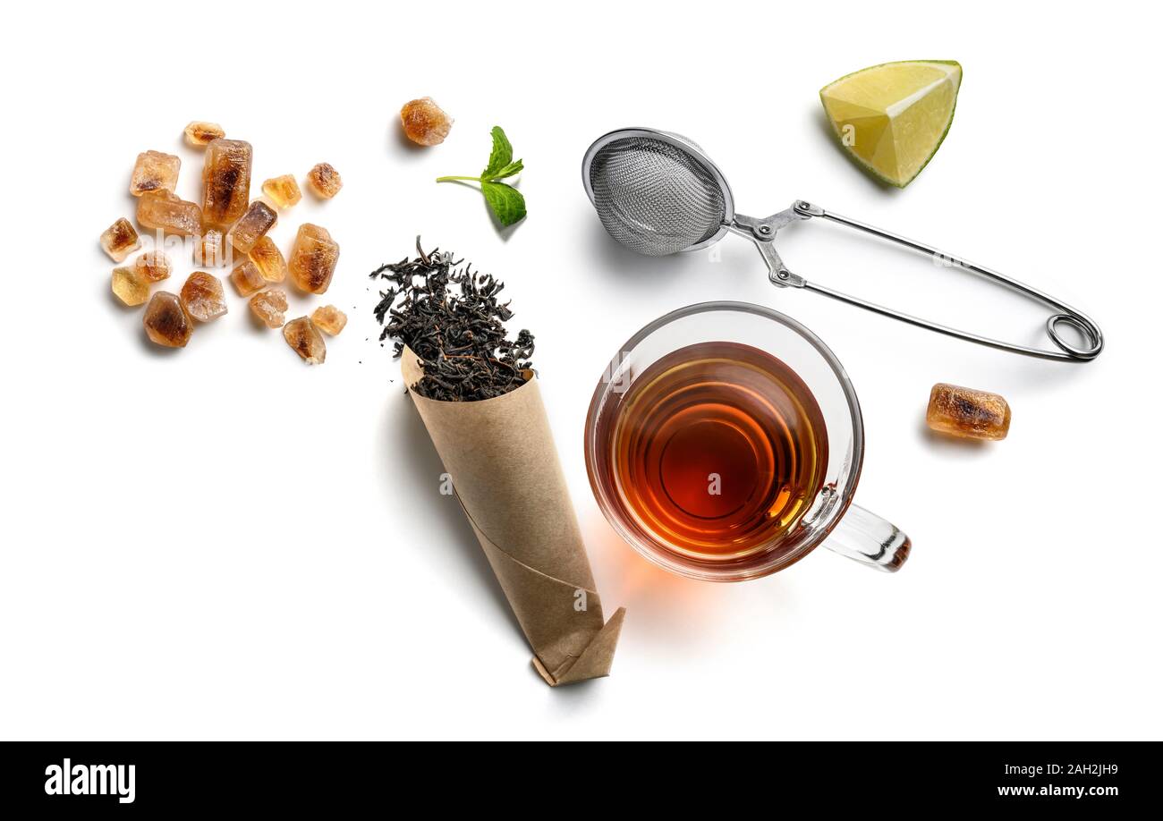 Black tea and accessories top view on white background Stock Photo - Alamy