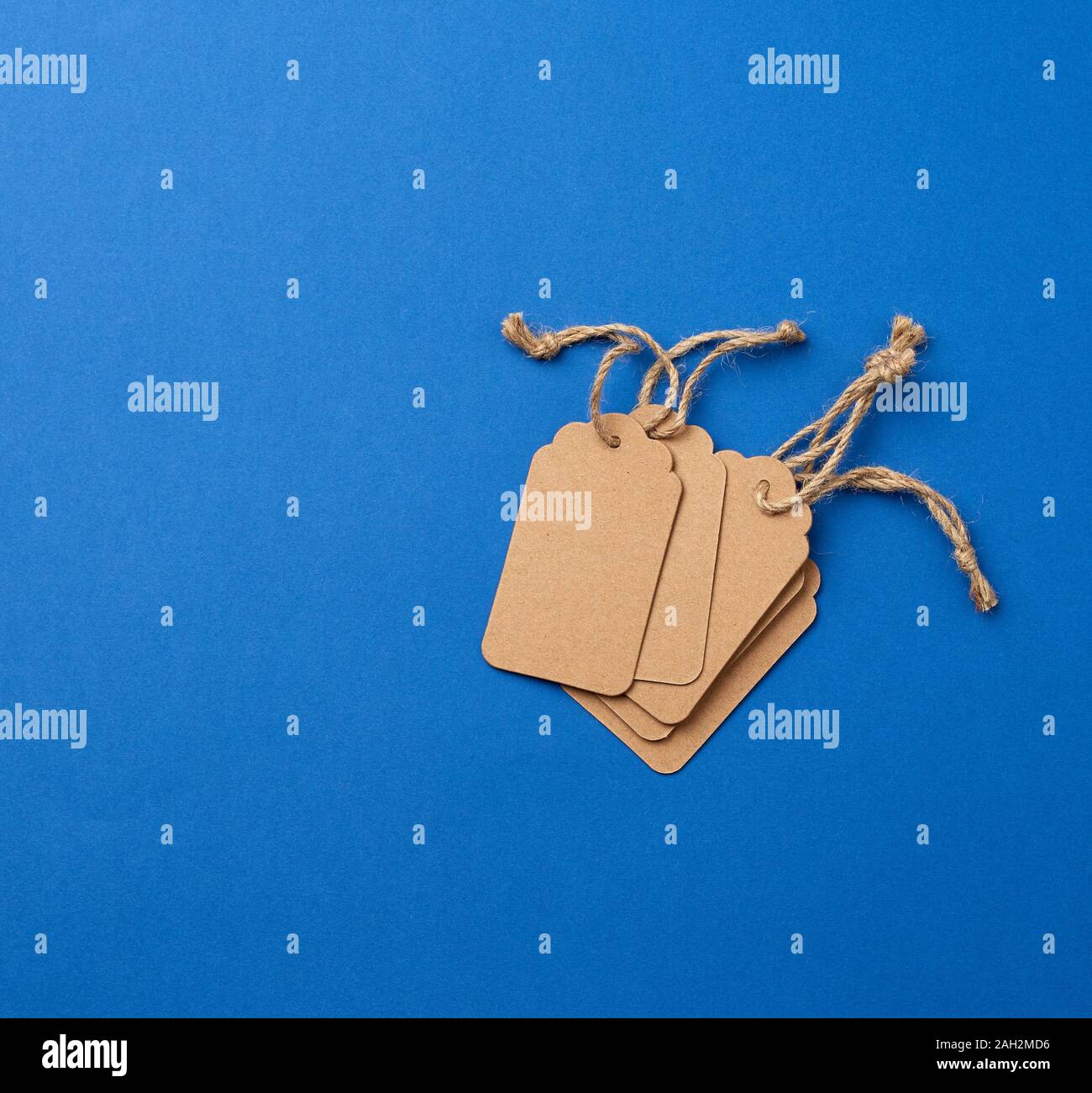 set of empty paper brown rectangular tags on a rope, price tags are on ...