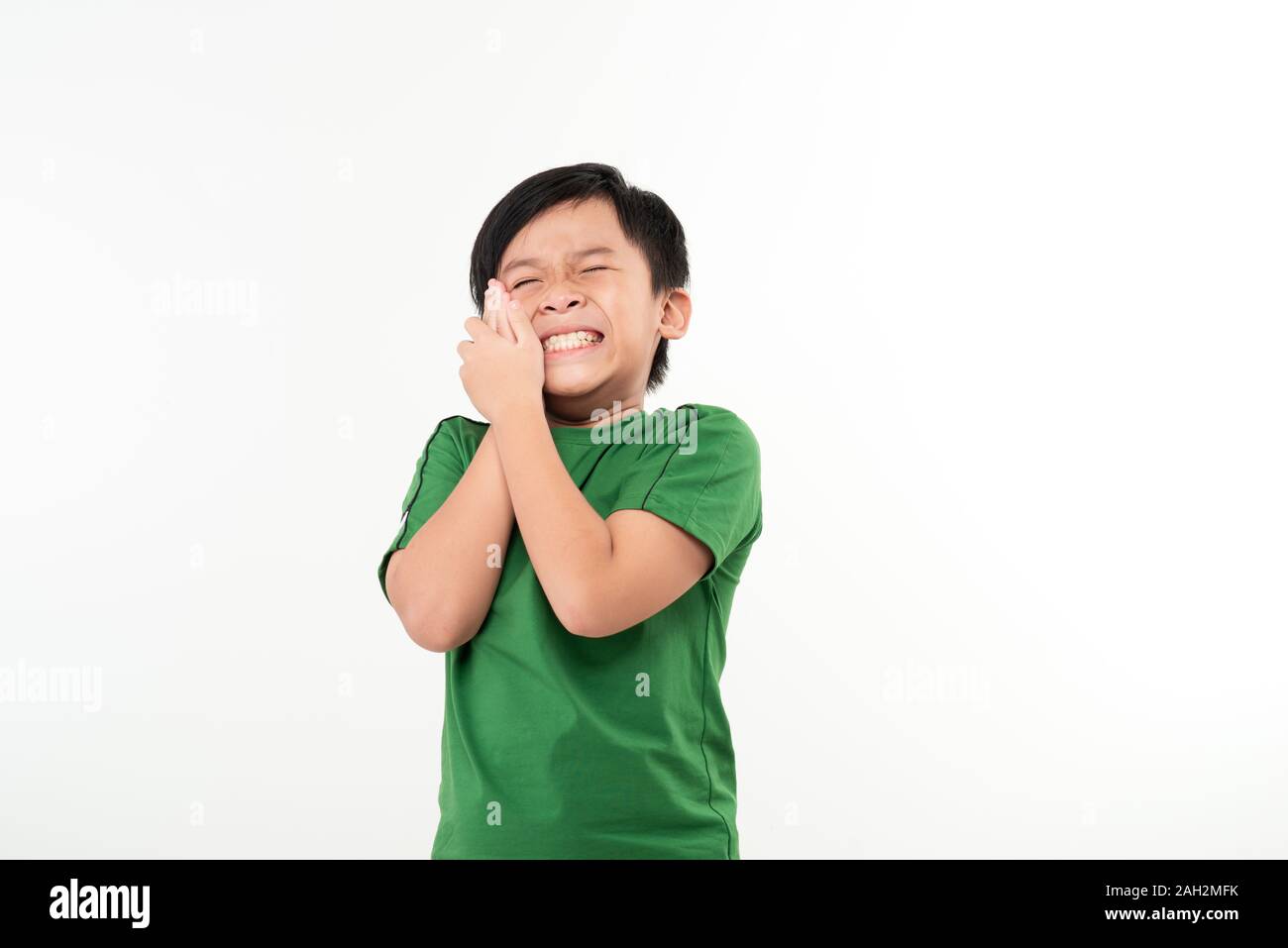 Handsome asian schoolboy with toothache hold his cheek with hand Stock ...
