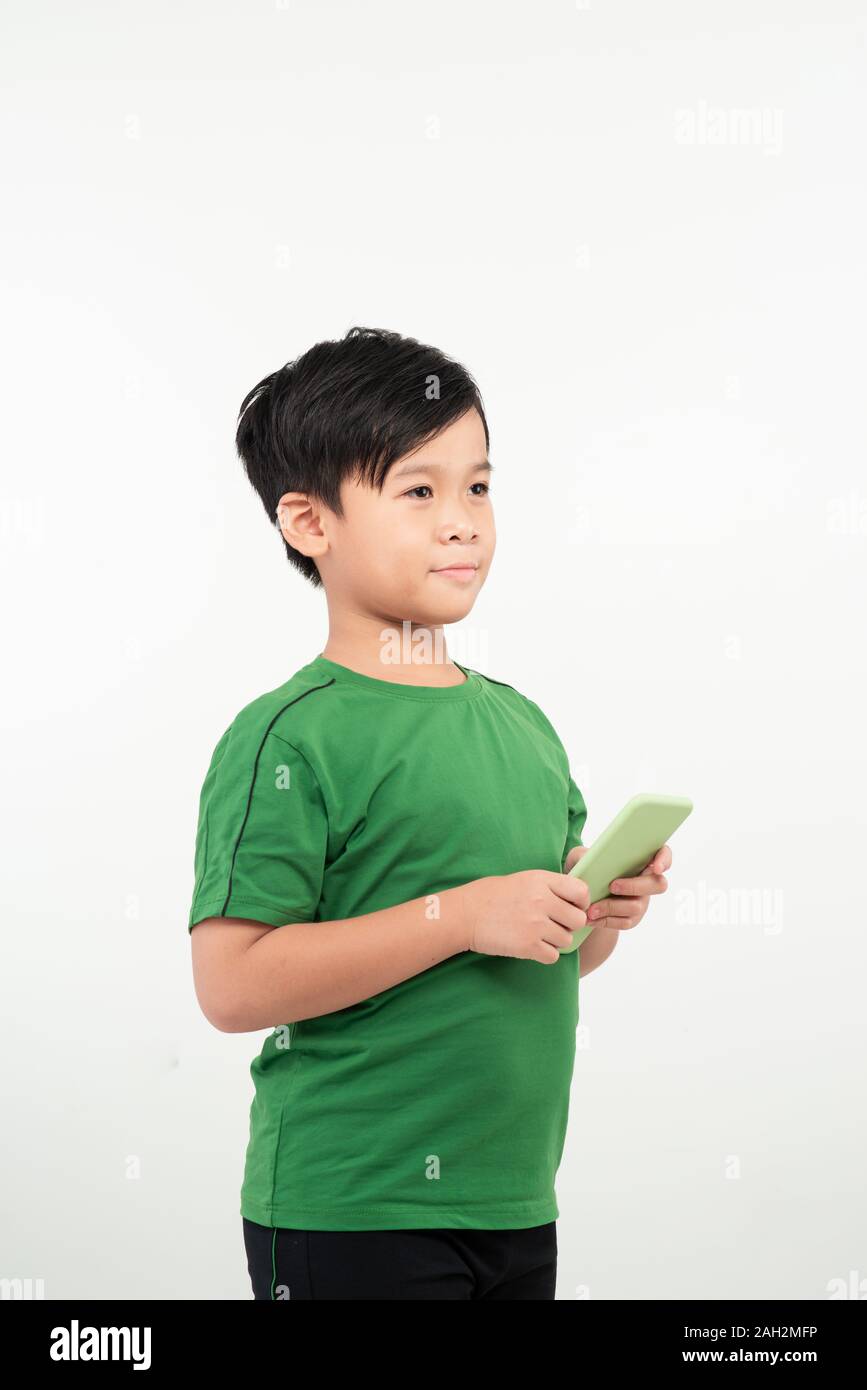 Cute little boy using cellphone isolated over white background, focus ...