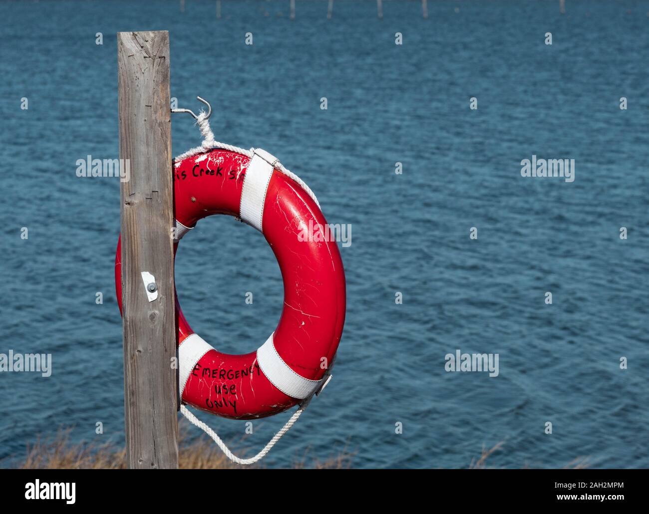 Life Preserver Secured to a Post at the lake Stock Photo - Alamy