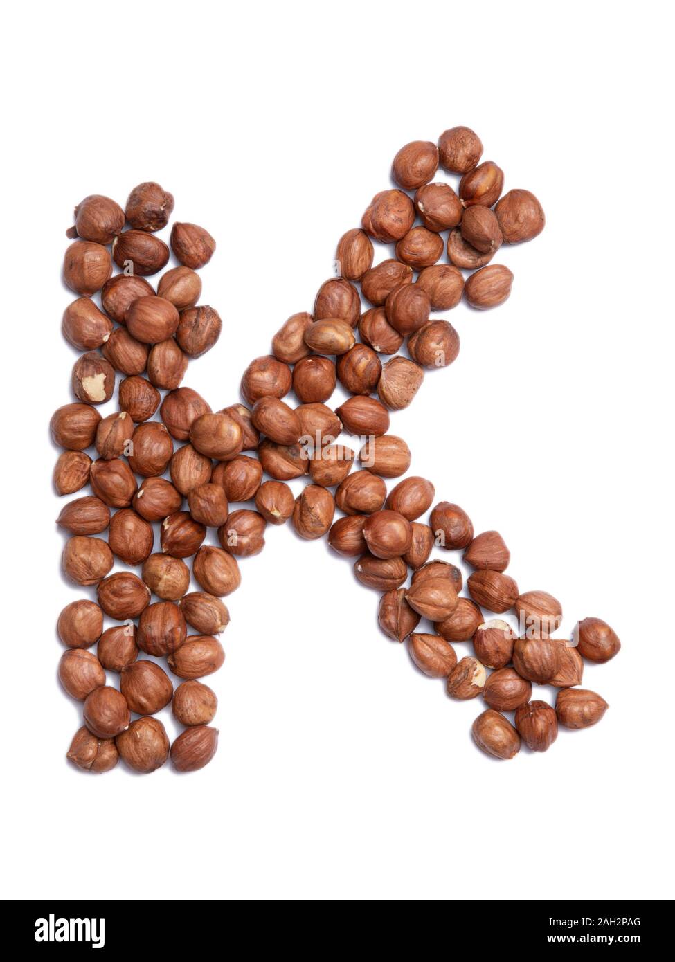 Letter K of the English alphabet from from hazelnut on a white isolated ...
