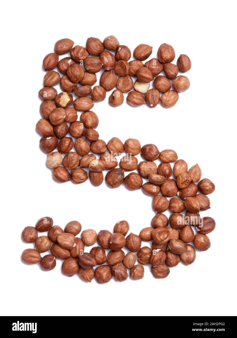 Arabic numeral "5" from peeled hazelnut on a white isolated background ...