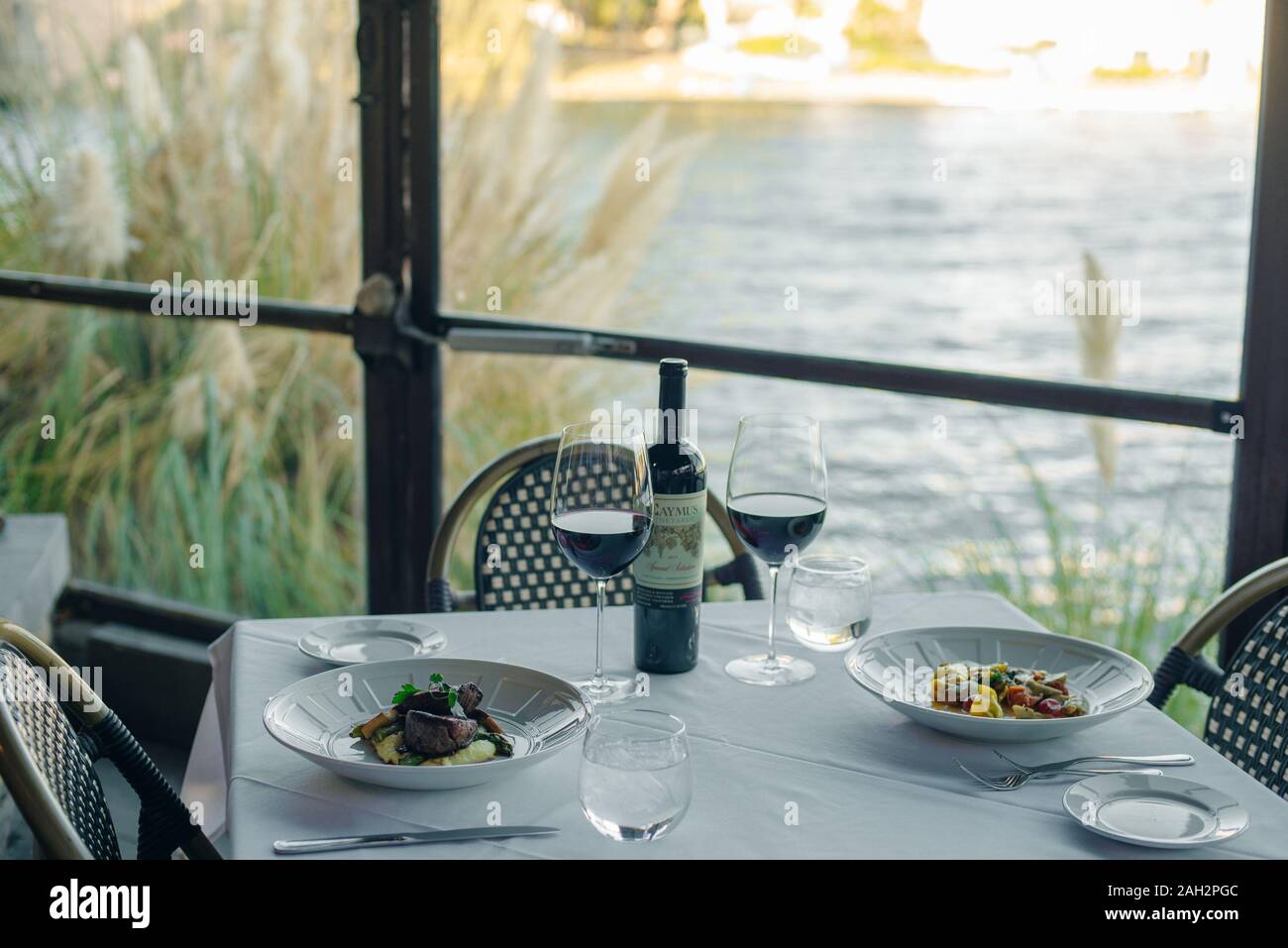 dining table in the restaurant overlooking the lake Stock Photo - Alamy