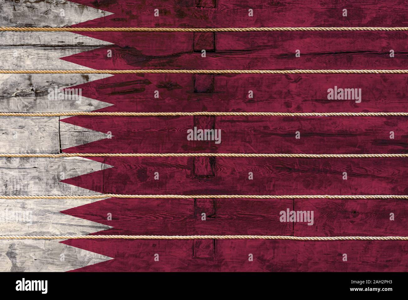 National flag of Qatar on a wooden wall background. The concept of ...