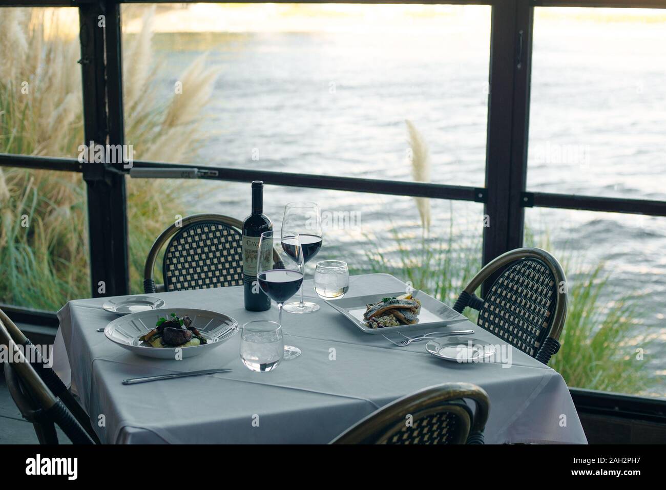 dining table in the restaurant overlooking the lake Stock Photo - Alamy