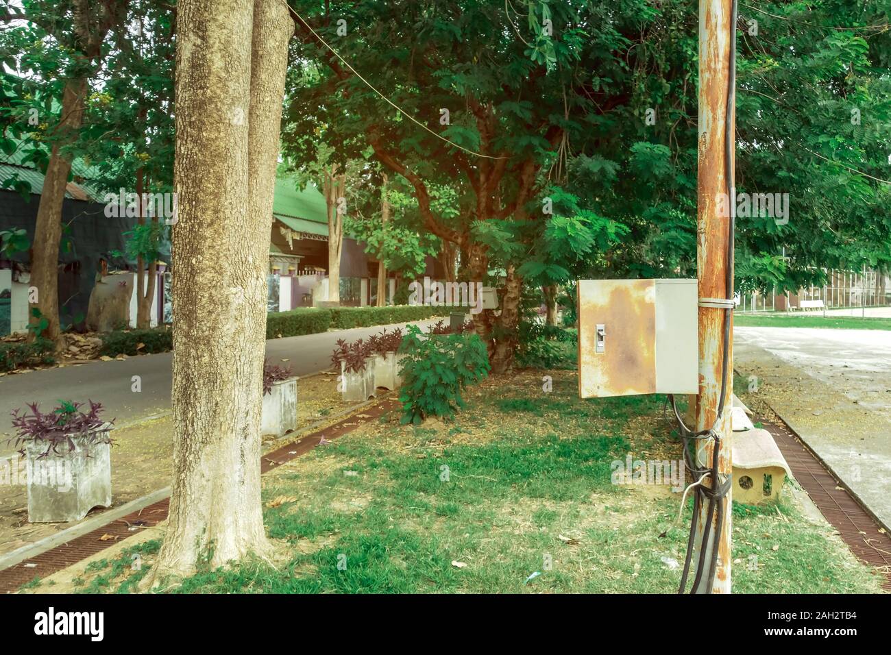 Old rusty electrical power control box on rusted electric pole in the ...
