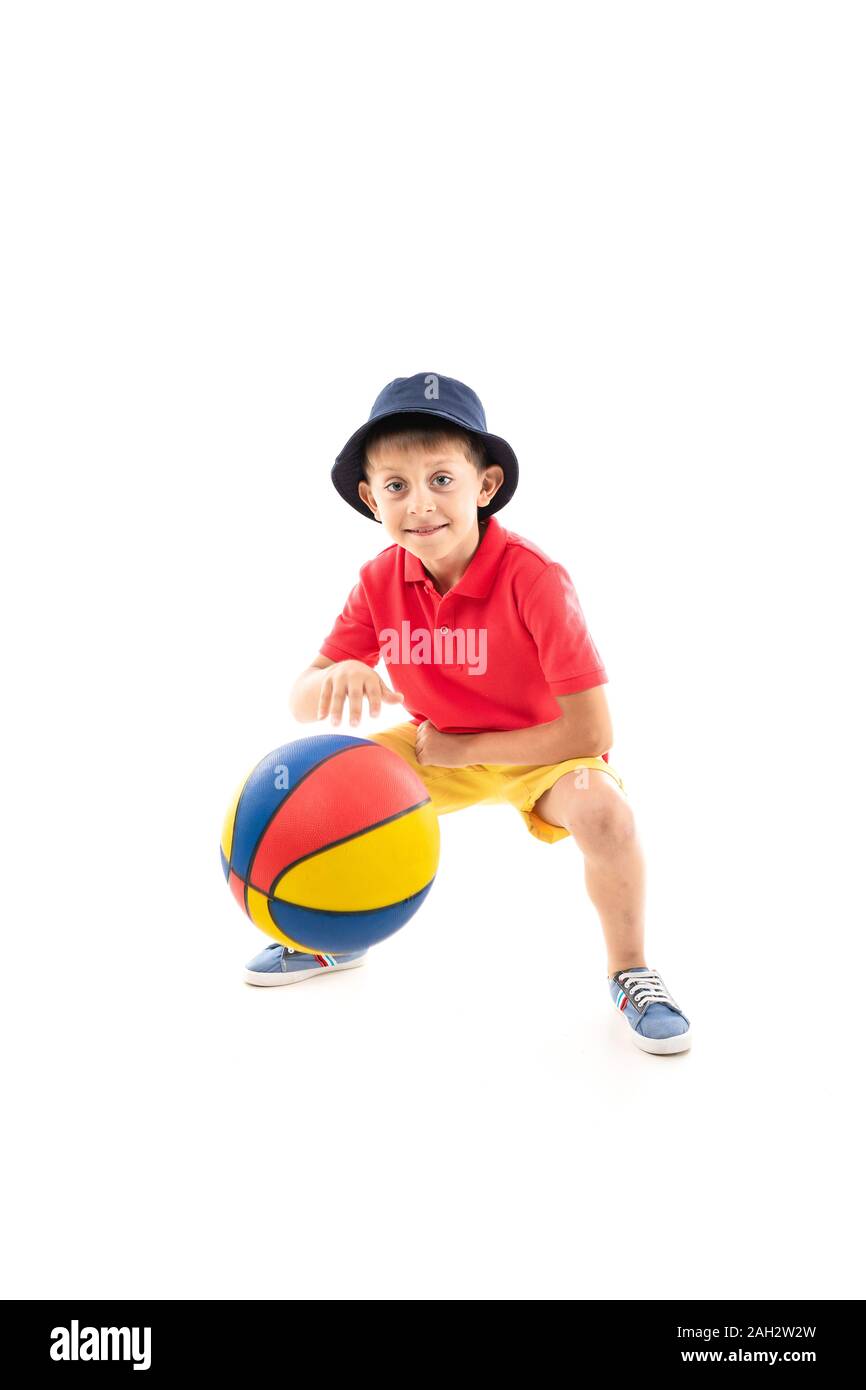 attractive young sporty smiling child throws a basketball ball on a ...