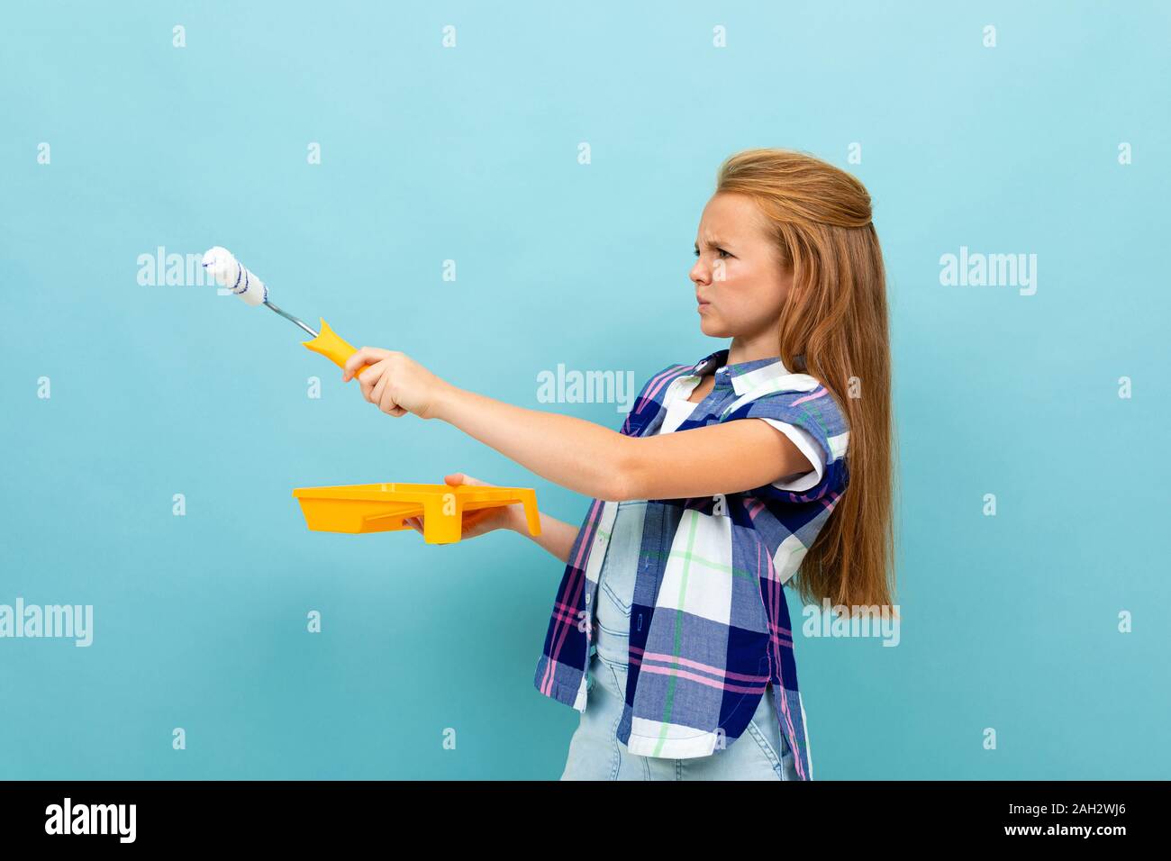 girl paints a light blue wall Stock Photo - Alamy