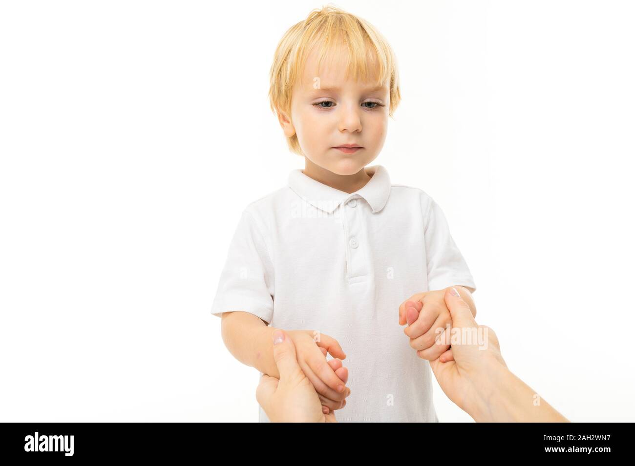 little blond boy hold hands on white background Stock Photo - Alamy