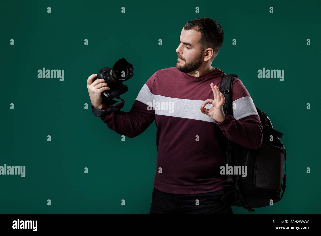 bearded man photographer takes images with professional digital photo ...