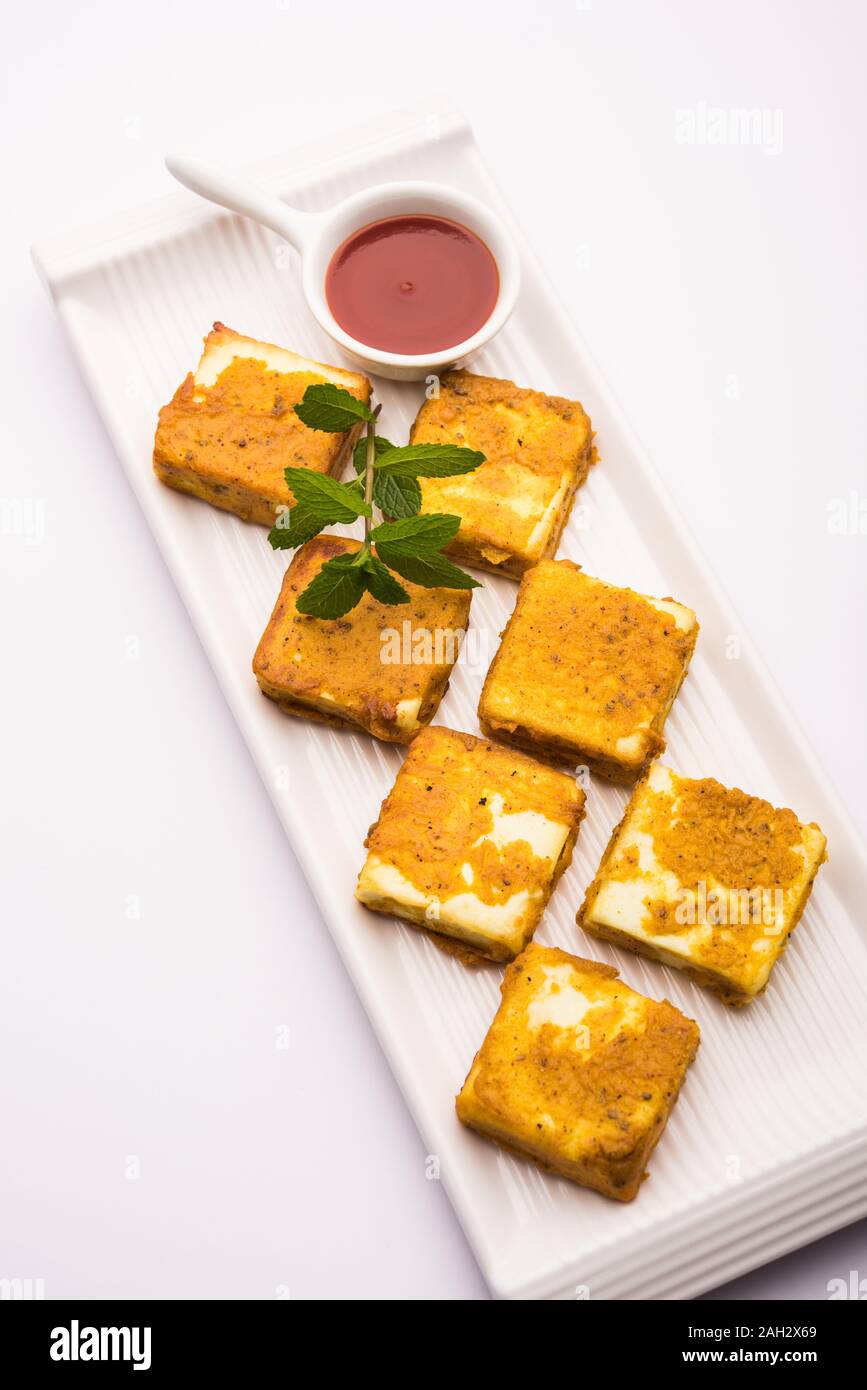 Amritsari Paneer Tikka made using cottage cheese cubes dipped in a ...