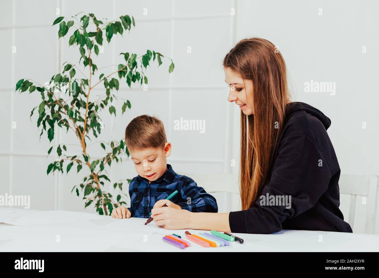 little boy draws markers from lesson mother Stock Photo - Alamy