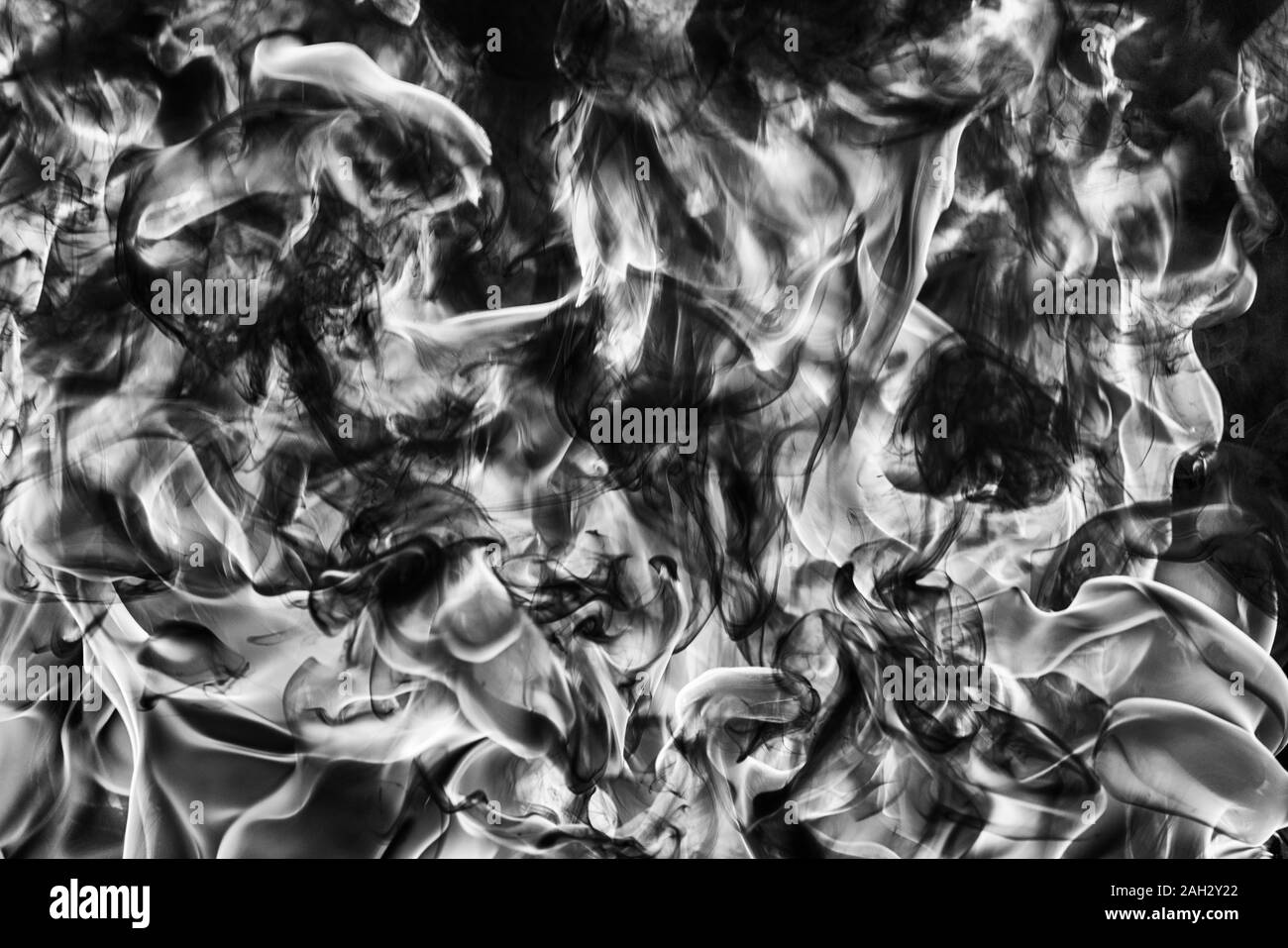 Abstract puffs of natural black smoke and white huge flame of strong ...