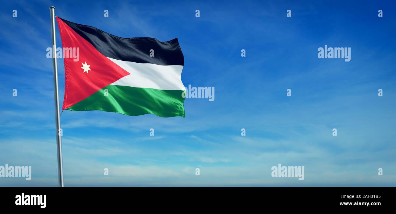 The National flag of Jordan blowing in the wind in front of a clear ...