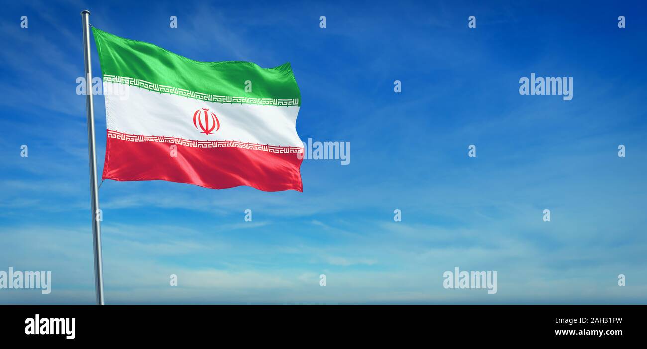 The National flag of Iran blowing in the wind in front of a clear blue ...
