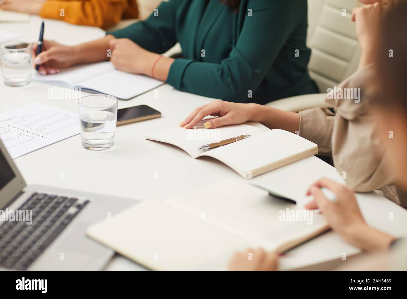 Horizontal high angle shot of urecognizable women sitting at office ...