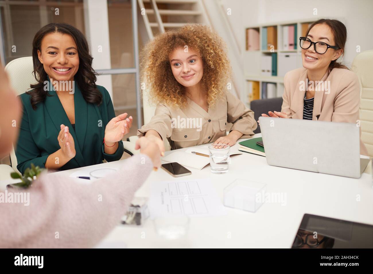 Successful business partners clenching bargain in modern office board ...