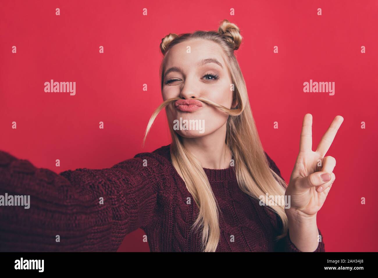 Closeup photo of pretty lady making false moustache with curl making selfies showing v-sign ...