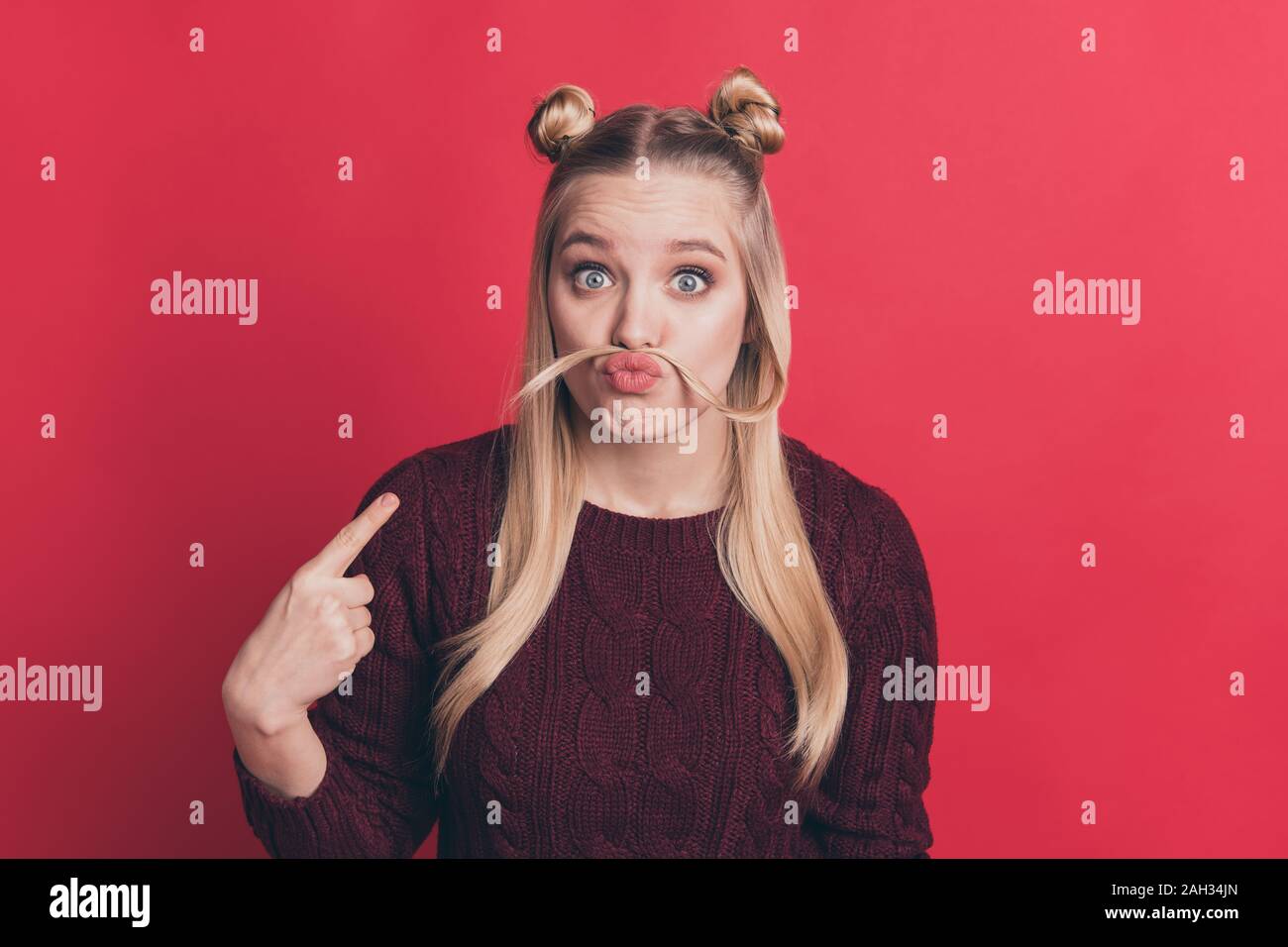 I'm like guy. Photo of pretty lady making false moustache with long curl directing finger on ...