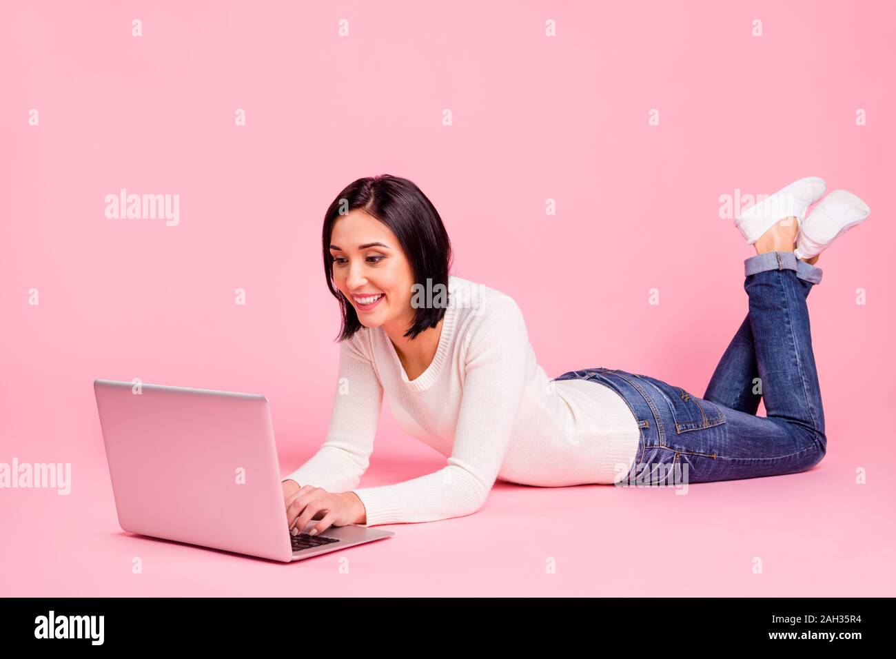 Full body photo of charming lady lying floor making homework using ...