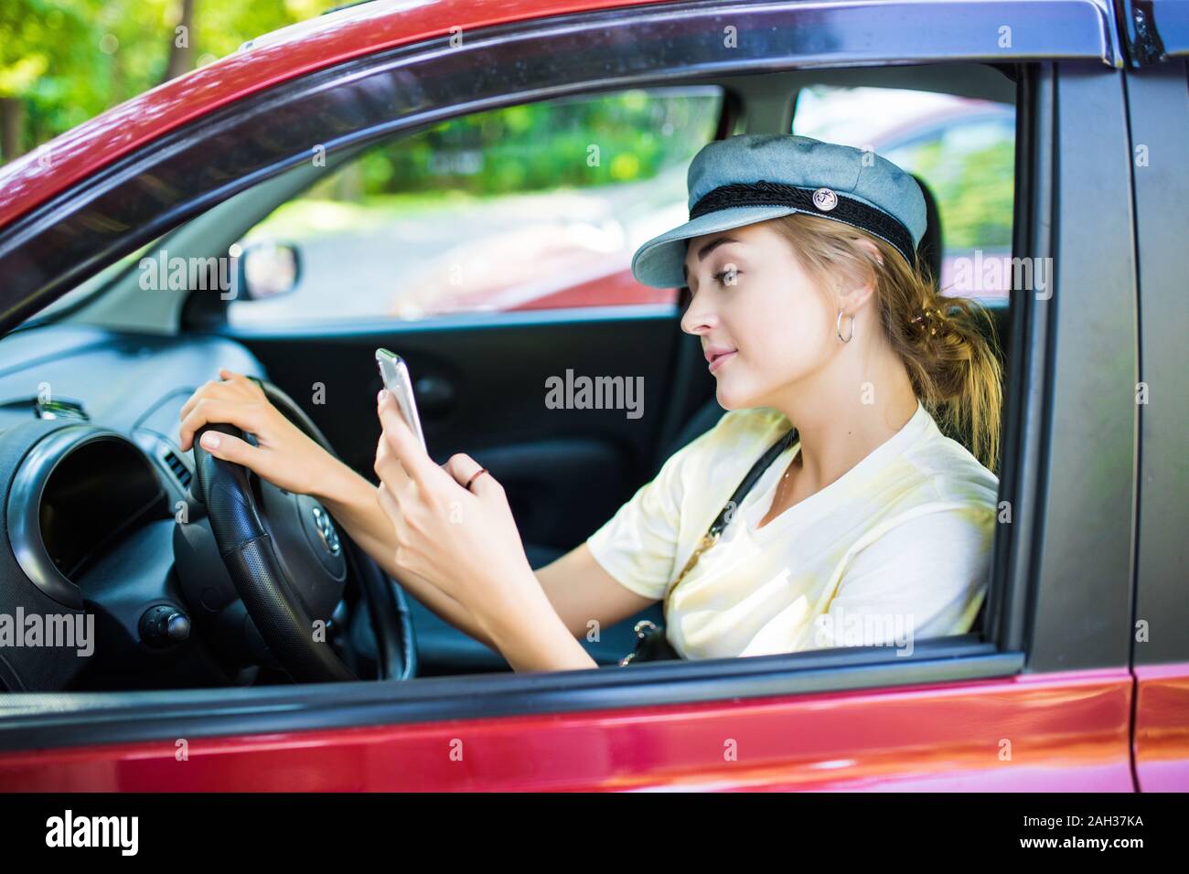 Young Woman Sending Messages while Driving Stock Photo - Alamy