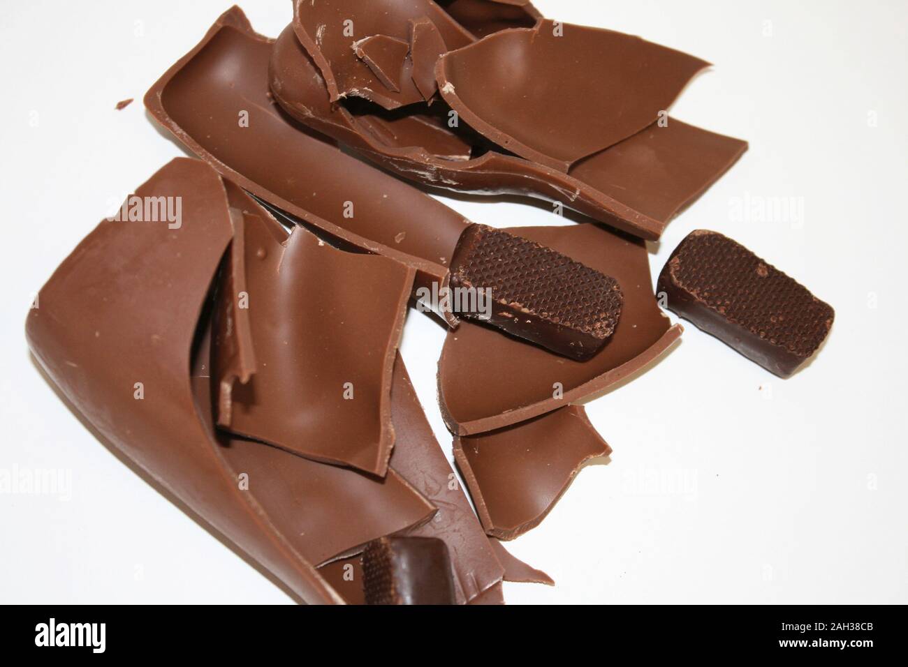 Broken chocolate on white background Stock Photo - Alamy