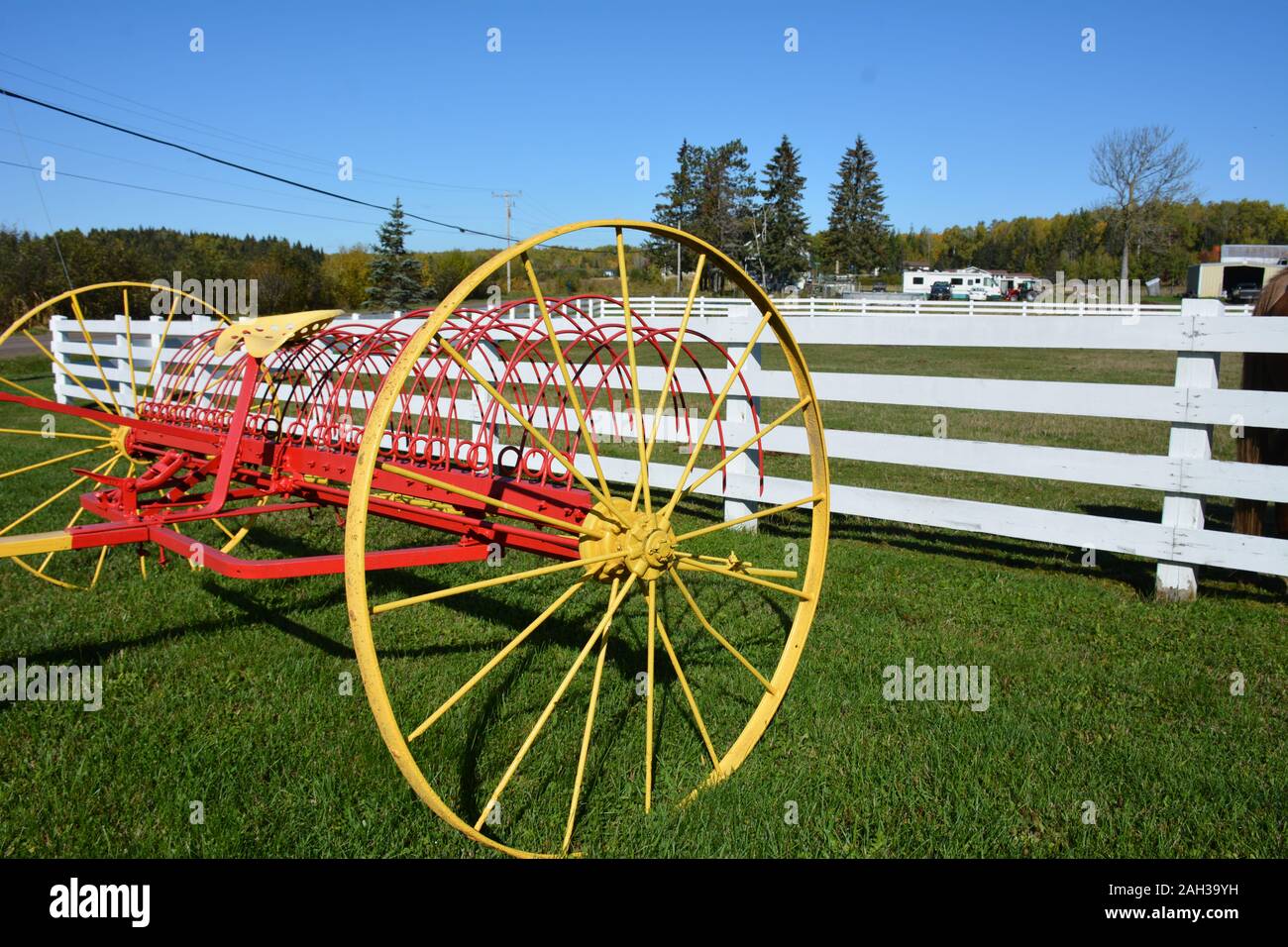 Refurbished red and yellow farm machinery Stock Photo - Alamy